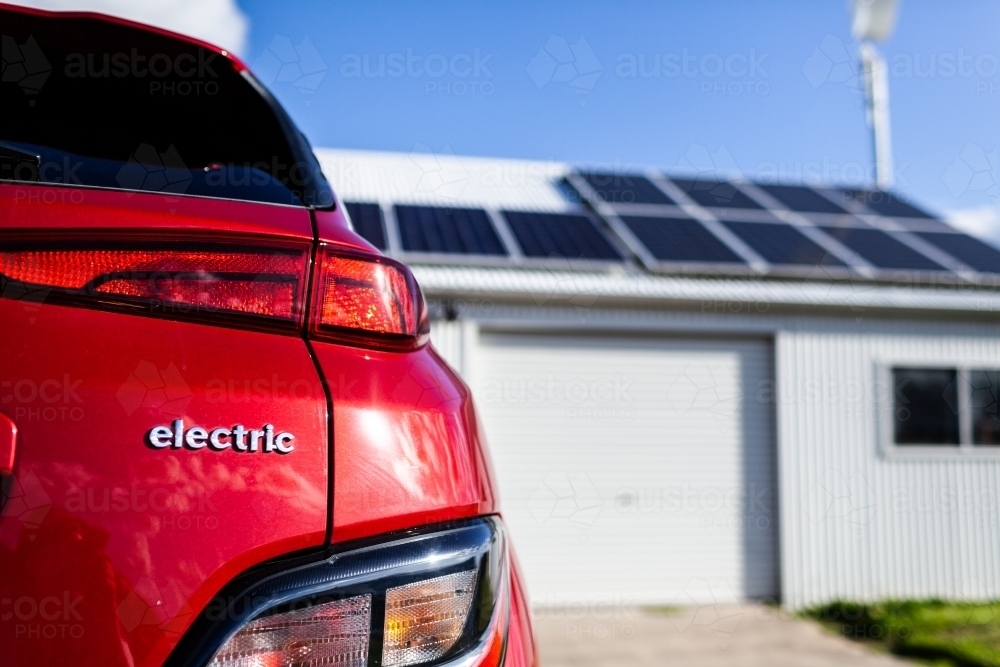 Image of Red electric vehicle with copy space and out of focus solar ...