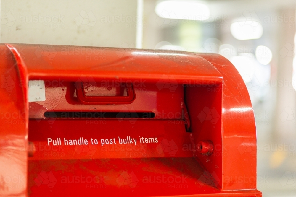 Image of Red post box - pull handle to post bulky items - Austockphoto