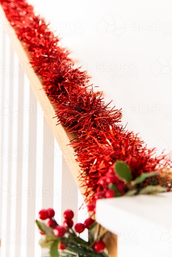 Image of red tinsel on a staircase handrail - Austockphoto