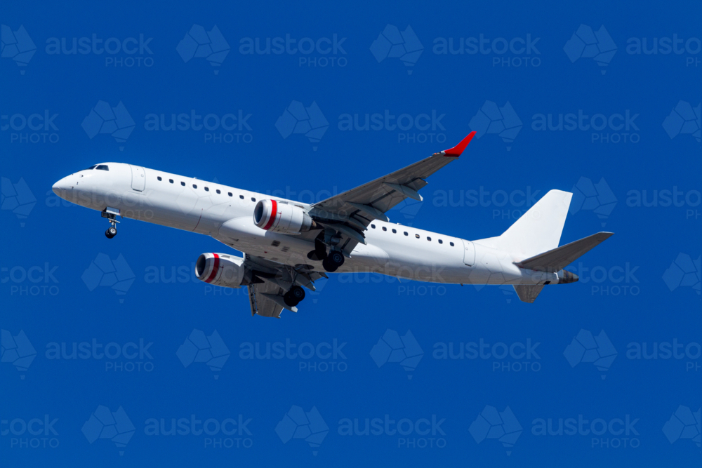 Image of Regional jet under a deep blue sky. - Austockphoto