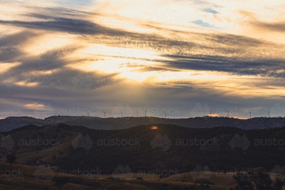 Image of Regional NSW sunset landscape with wind turbines on ridgeline ...