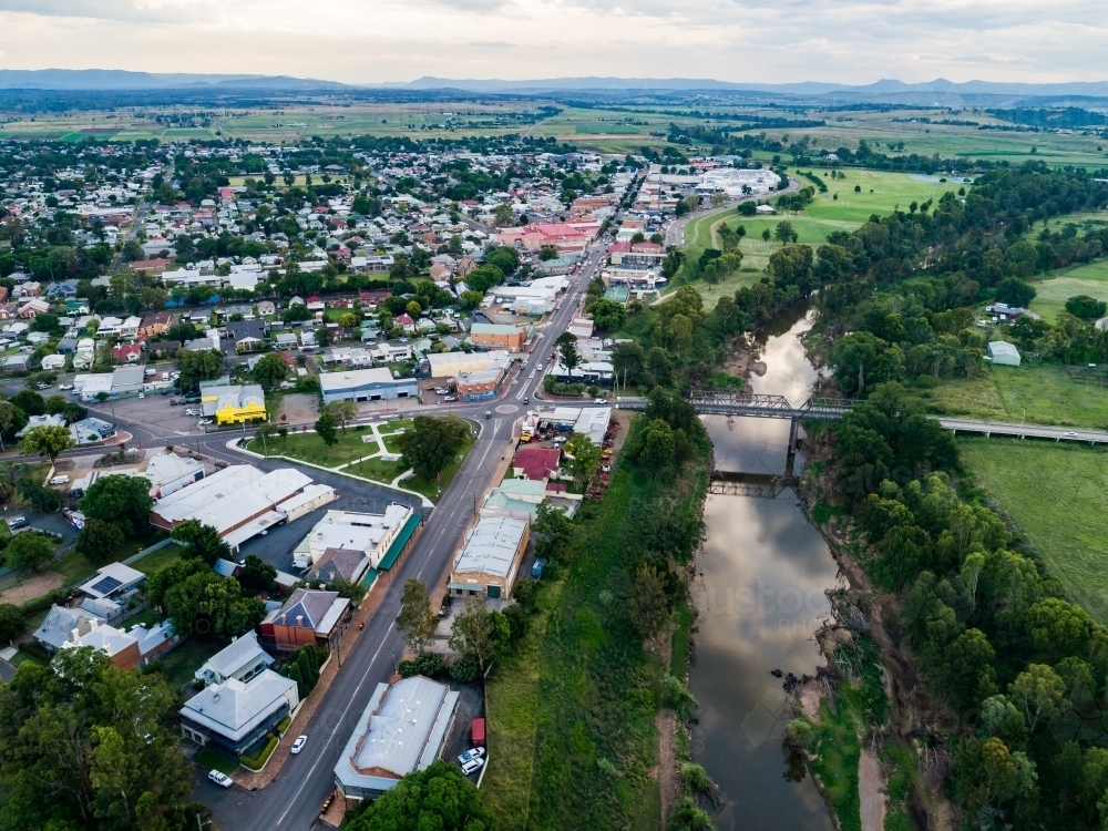 Image of River reflecting clouds beside main street of country town ...