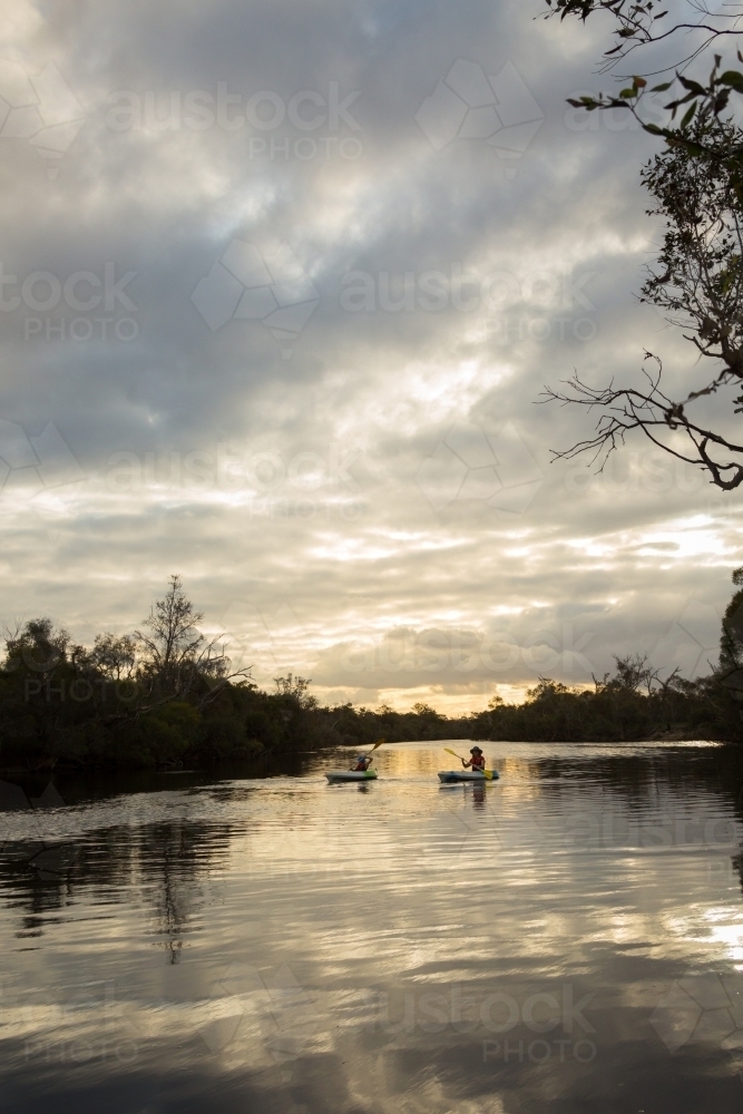 Image of River scene with two people paddling kayaks - Austockphoto