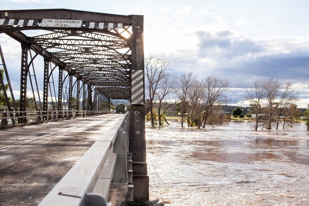 Image of River with broken bank and floodwater over farmland beside ...