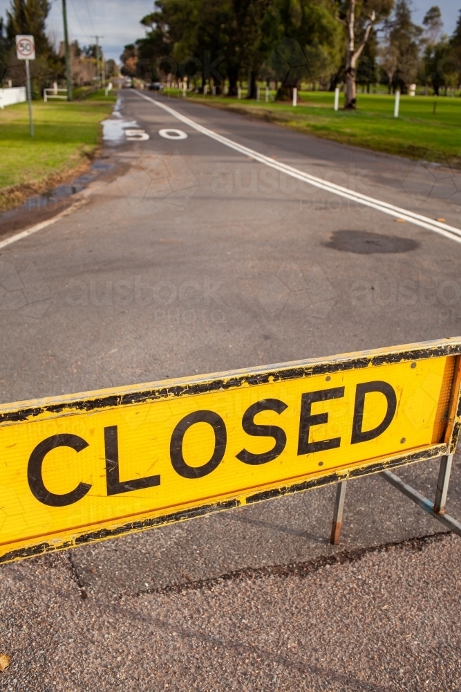 Image of Road closed sign in town during flood - Austockphoto