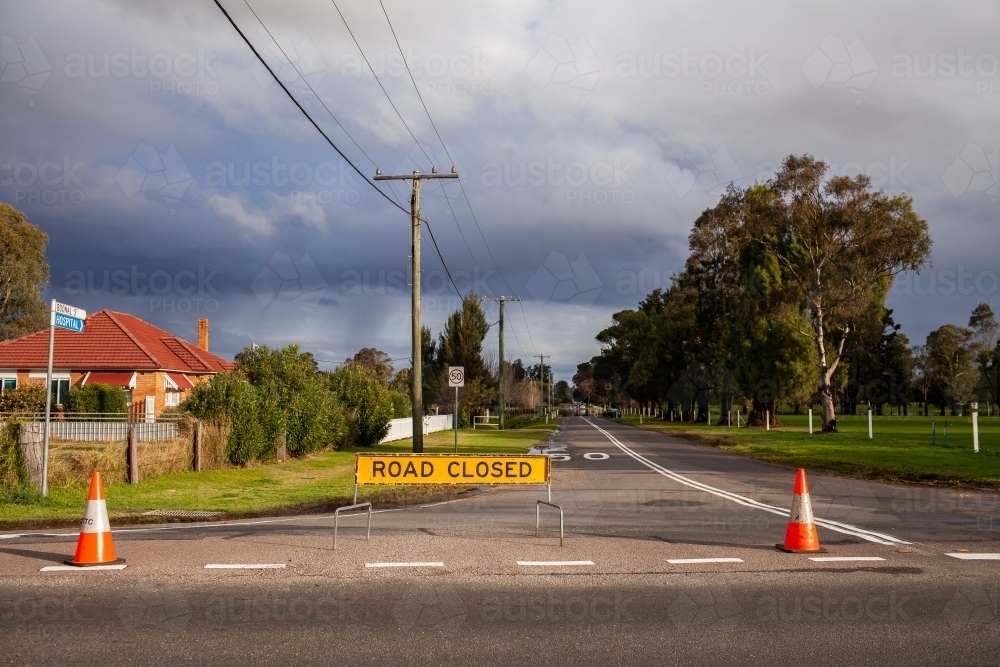 Image of Road closed sign in town during flood with more rain in ...