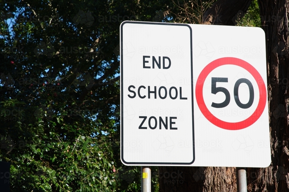 Image of road sign indicating the speed limit and end school zone with ...
