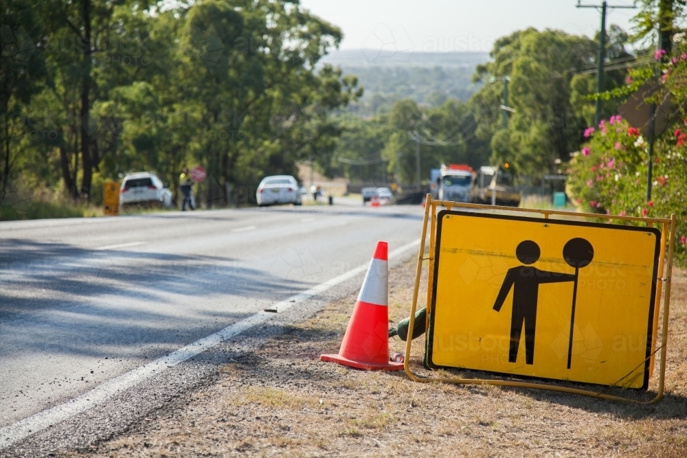 Image of Road work warning sign on road - Austockphoto
