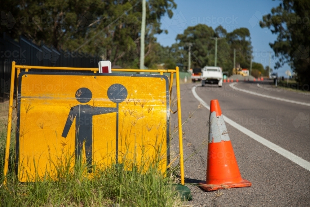 Image of Road work warning sign on road - Austockphoto