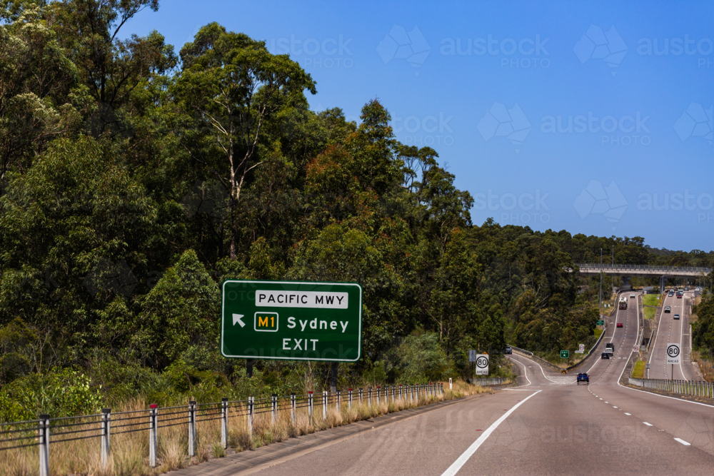 Image of roadside sign with arrow saying pacific highway M1 Sydney exit ...