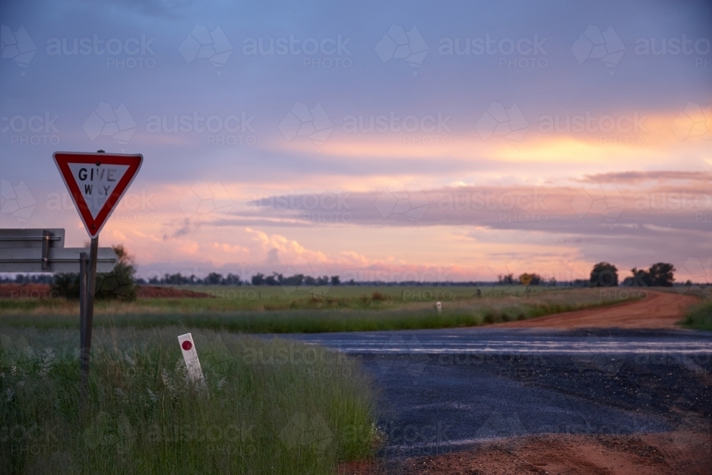 Image of Roadside signage with dramatic sunset - Austockphoto