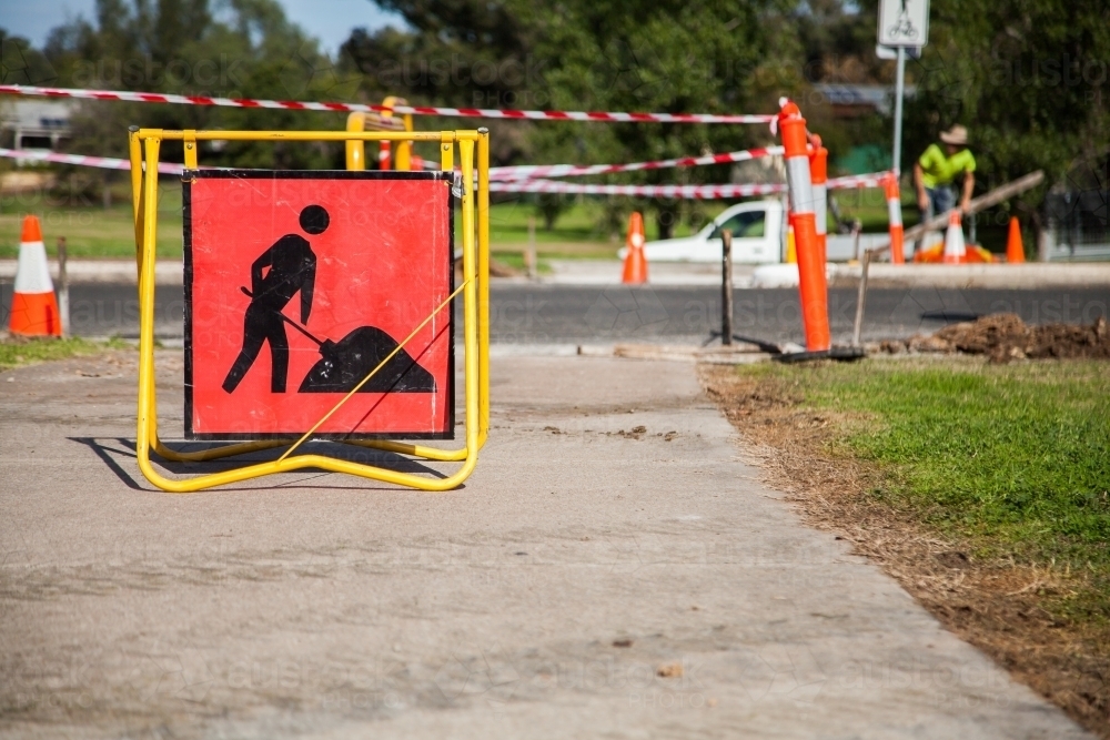 Image of Roadwork sign on footpath before taped off work-site area ...
