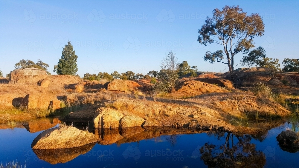 Image of Rock pool water hole on sunny afternoon - Austockphoto