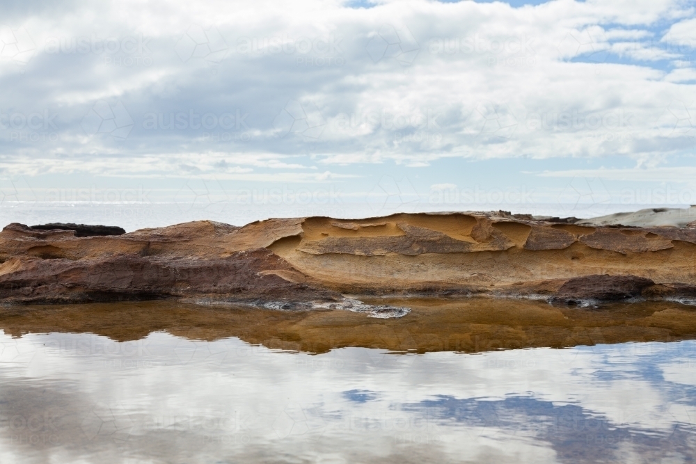 Image of Rockpool and water with ocean behind - Austockphoto