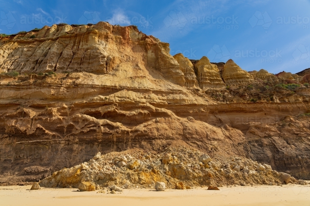 Image of Rocks and rubble at the base of a coastal cliff face after a ...