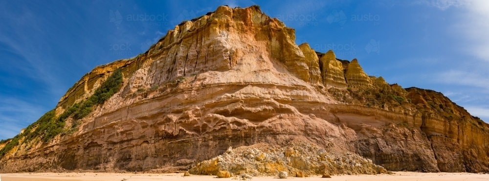 Image of Rocks and rubble at the base of a coastal cliff face after a ...