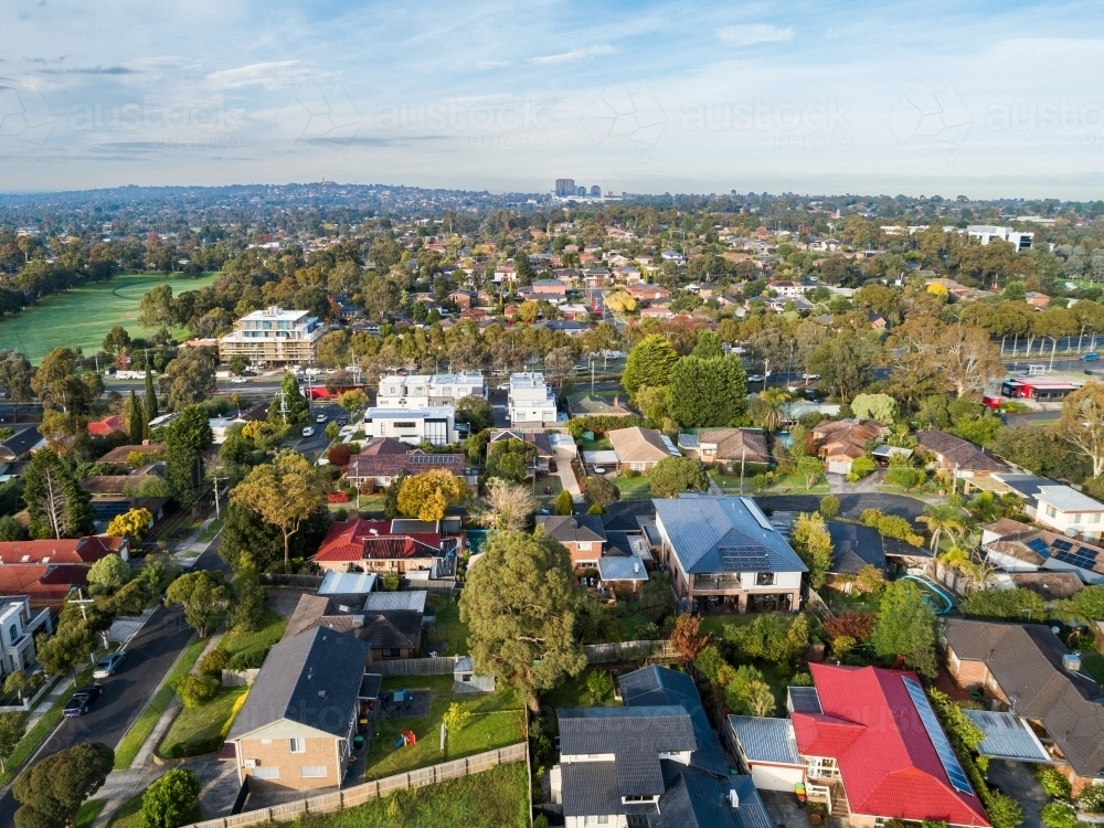 Image of rooftops of houses in city suburb in morning light - Austockphoto