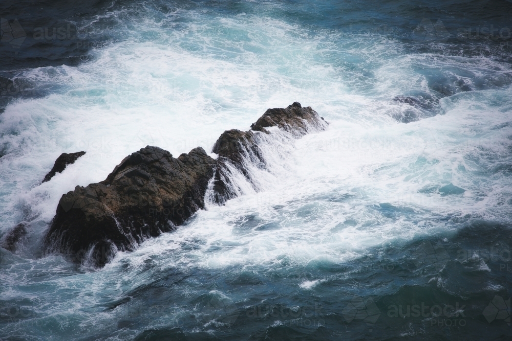 Image of Rough sea washing over rocks - Austockphoto