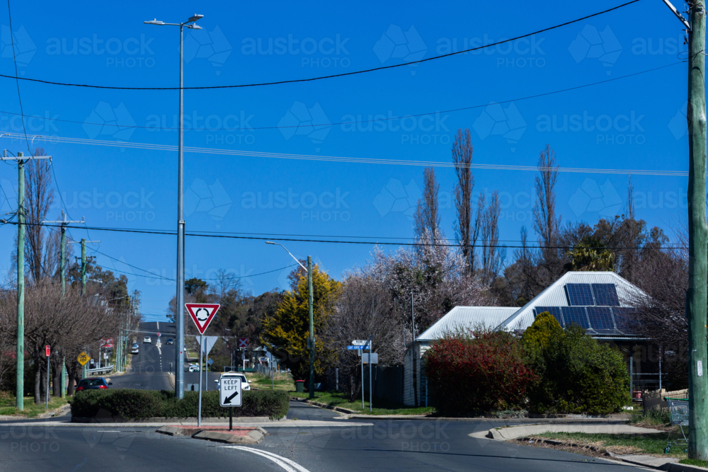 Image of roundabout at intersection of roads in town on late winter day ...