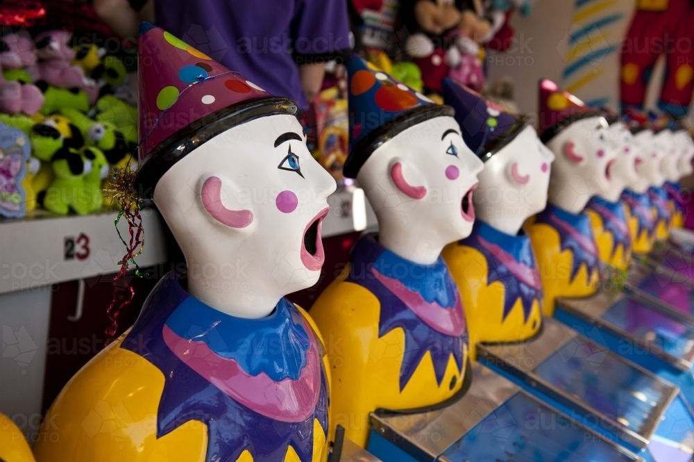 Image of Row of clown heads, turning away from camera - Austockphoto