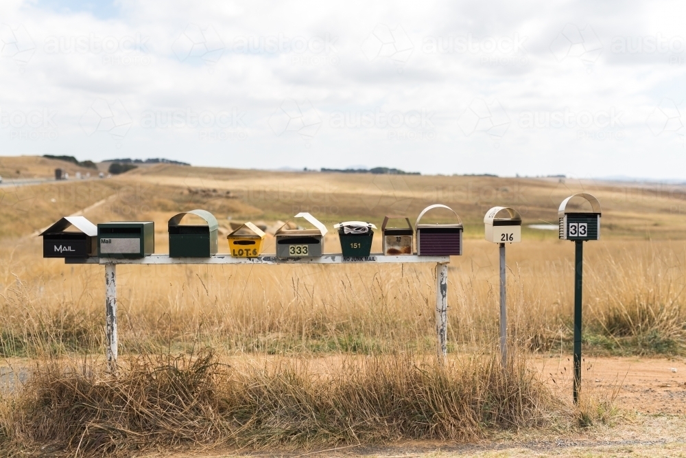 Image of row of mailboxes on a rural road - Austockphoto