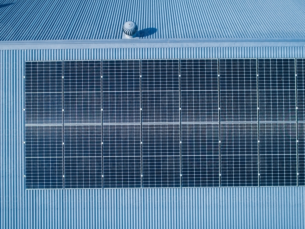 Image of Row of solar panels on tin roof seen from aerial view ...