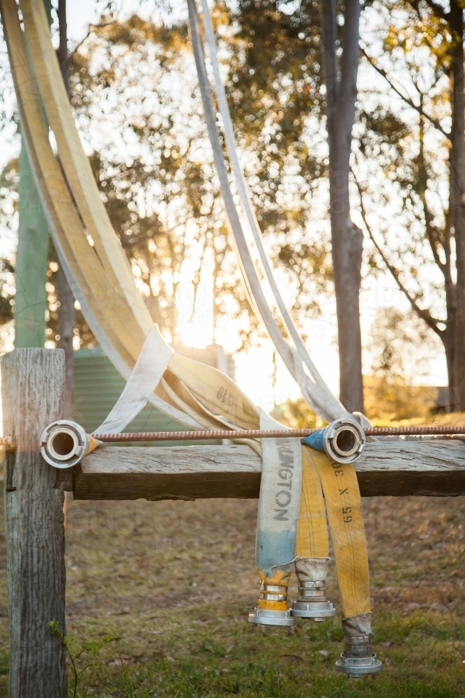 Image of Rural fire service fire fighting hose draped on drying frame ...