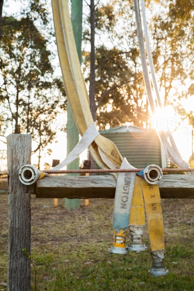 Image of Rural fire service fire fighting hose draped on drying frame ...