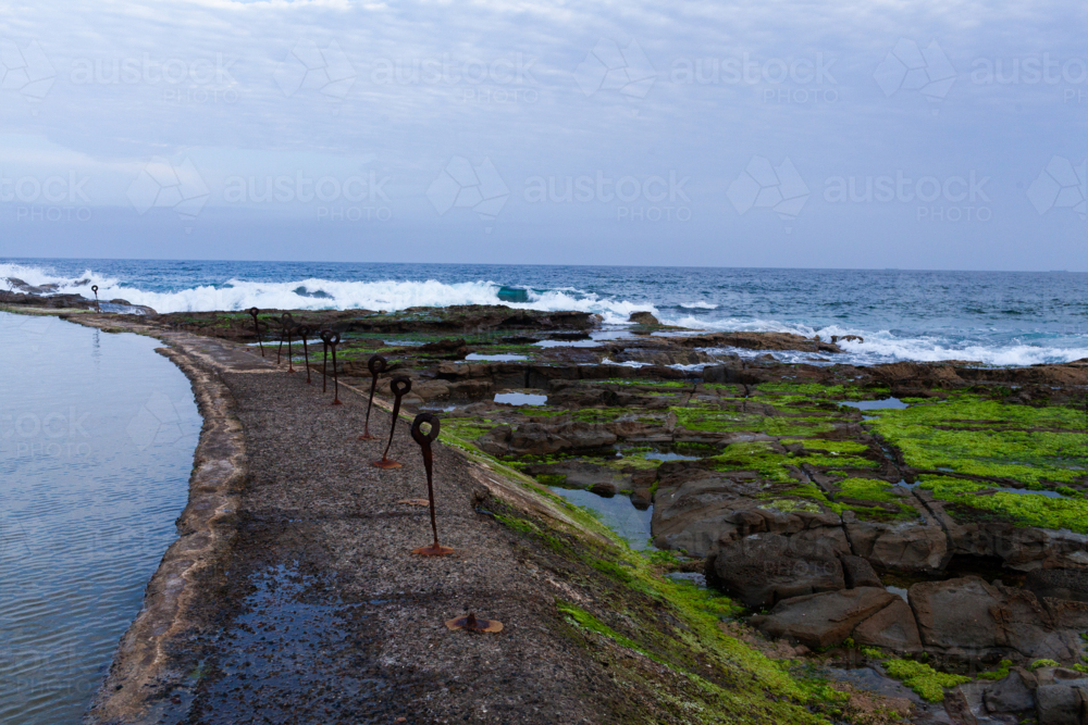 Image of Rusted posts alongside Newcastle Canoe Pool at the beach ...
