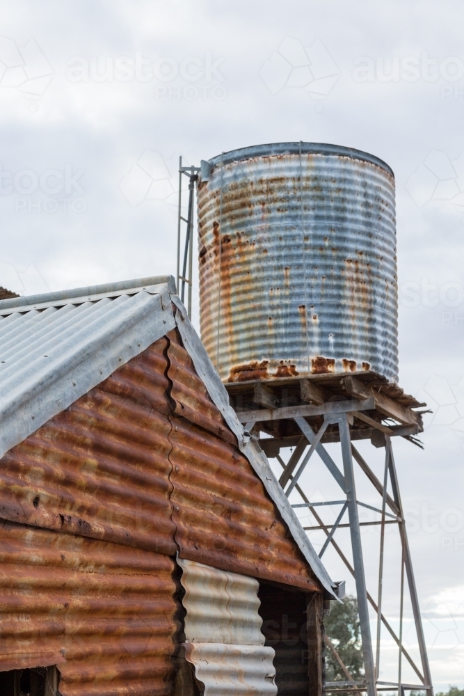 Image of Rusty old corrugated iron tank and shed - Austockphoto