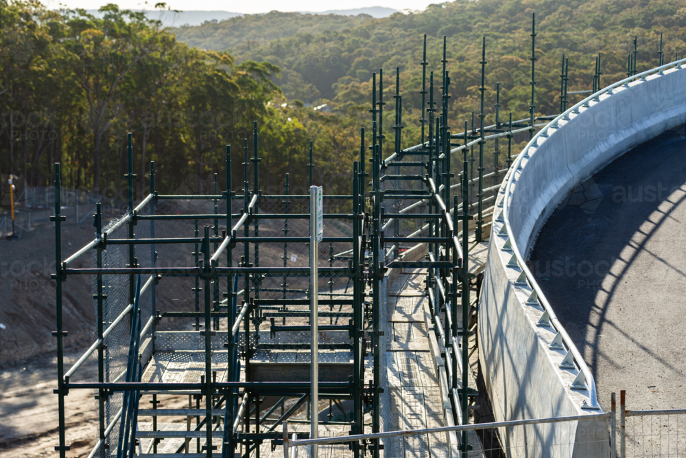 Image of scaffolding and platform beside bridge at worksite - Austockphoto