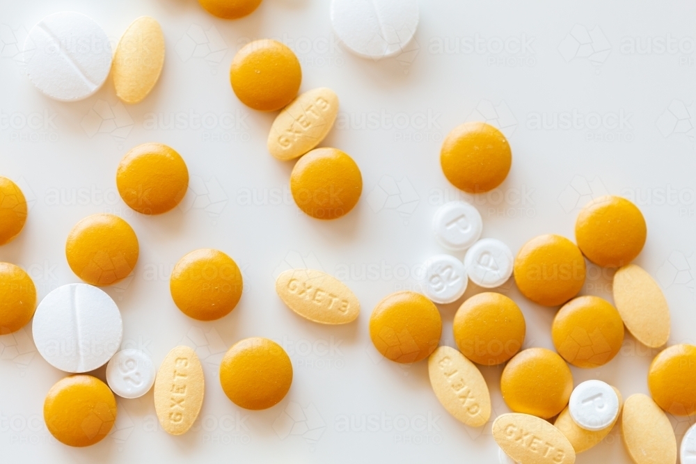 Image of Scattered orange and white medical pills for nausea and pain ...