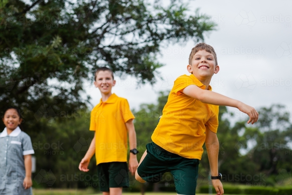 Image of School boy after throwing a ball in sports game - Austockphoto