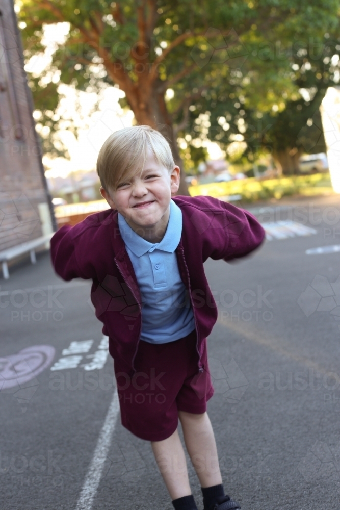 Image of School boy being silly for the camera - Austockphoto