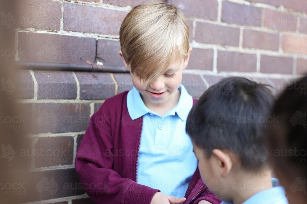 Image of School boys playing in the schoolyard - Austockphoto