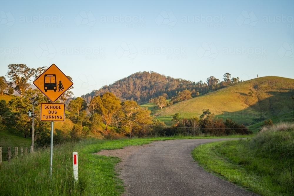 Image of School bus turning sign on rural country road at sunset ...