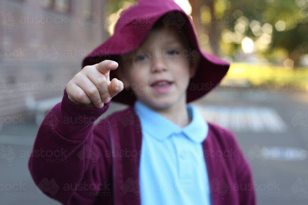 Image of School child pointing towards the camera - Austockphoto