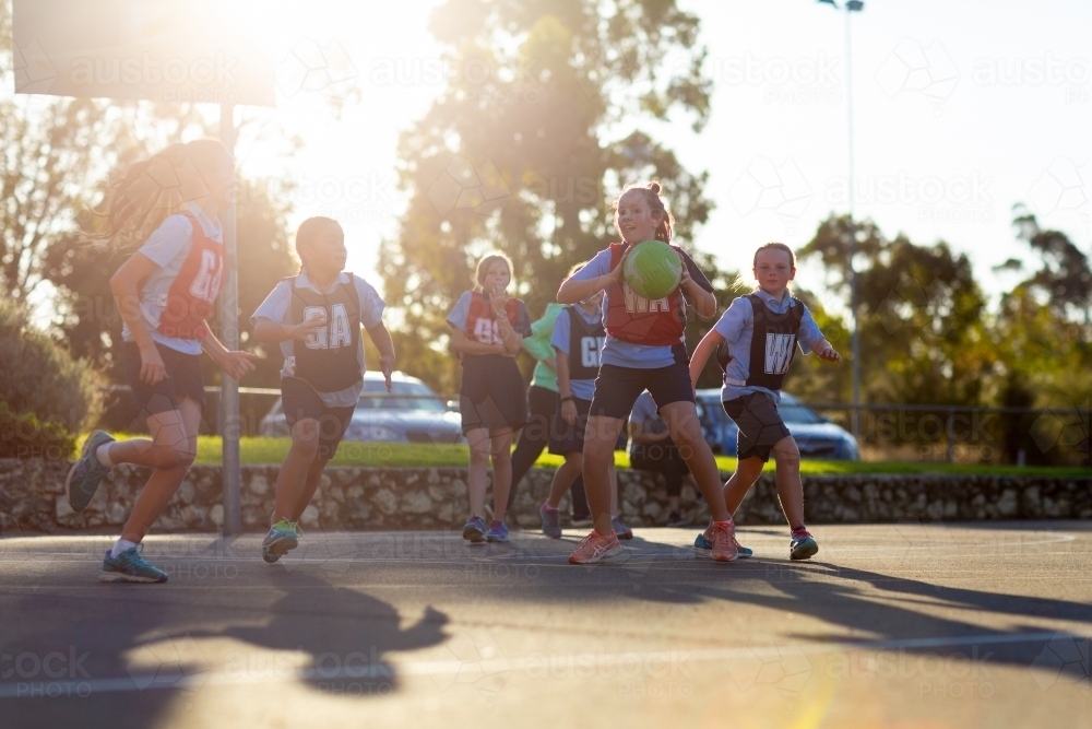 Image of School children playing netball - Austockphoto