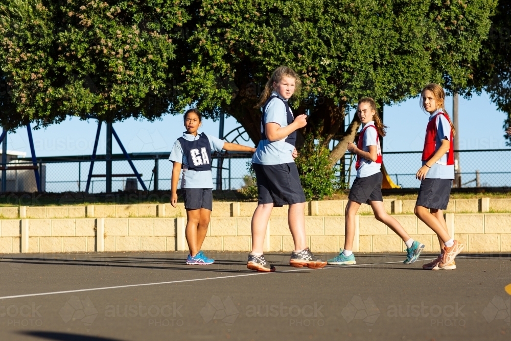 Image of School children playing netball - Austockphoto