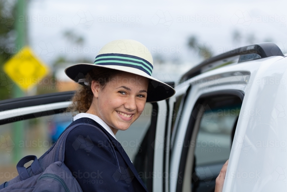 Image of School girl getting into car - Austockphoto