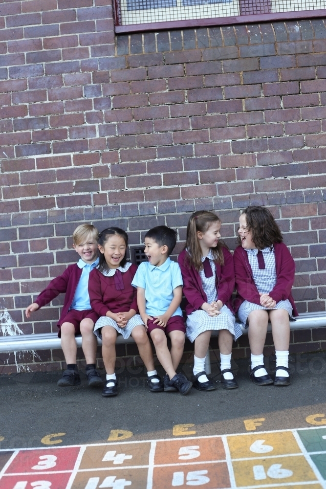 Image of School kids talking and laughing in the school playground ...