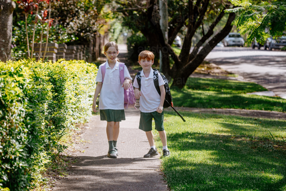 Image of School kids walking on a pathway home from school on sunny day ...