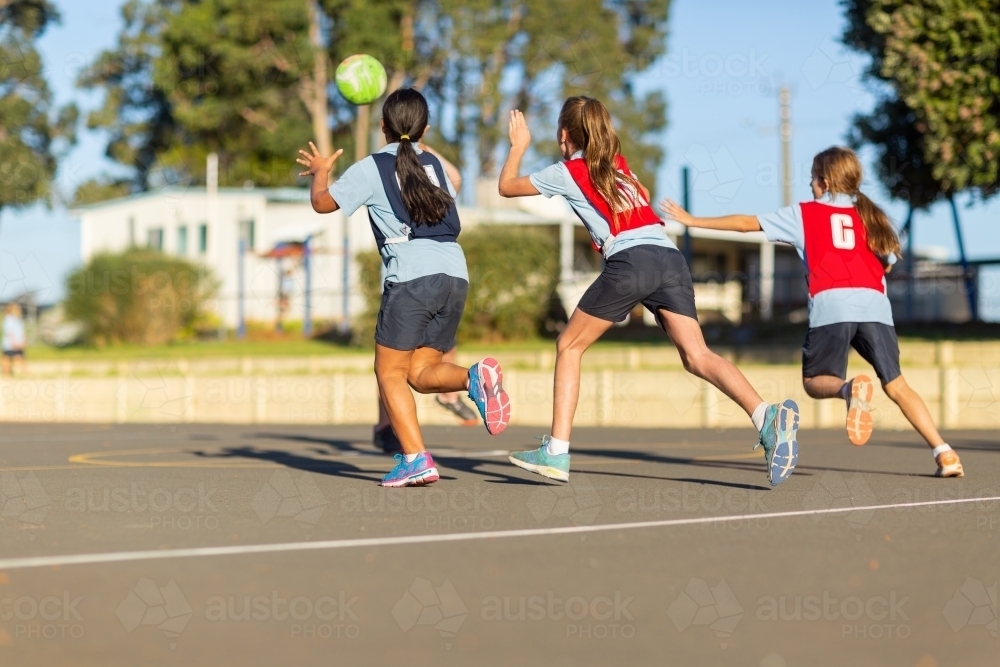 Image of Schoolgirls playing netball - Austockphoto