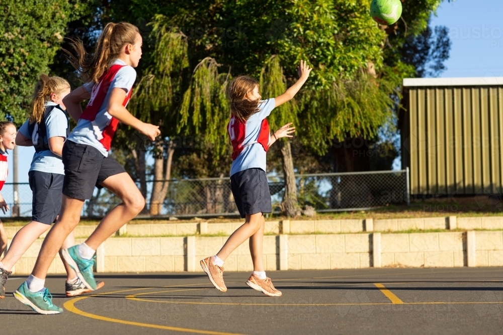 Image of Schoolgirls playing netball - Austockphoto