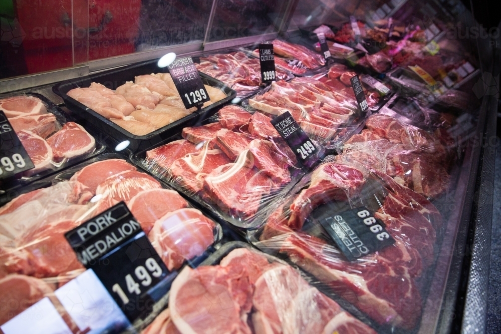 Image of selection of meats available at a butcher's shop - Austockphoto