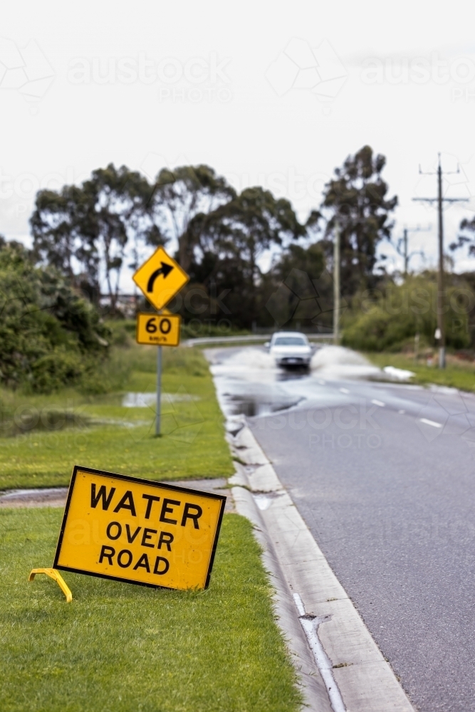 Image of selective focus on a 'water over road' sign with an out of ...