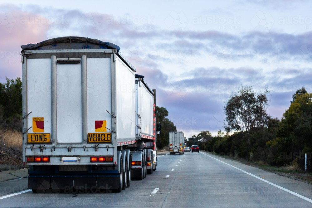Image of Semi trailer truck transporting goods down rural highway at ...