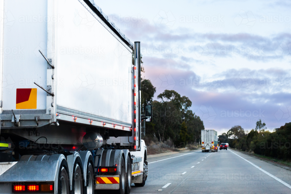 Image of Semi trailer truck transporting goods down rural highway at ...