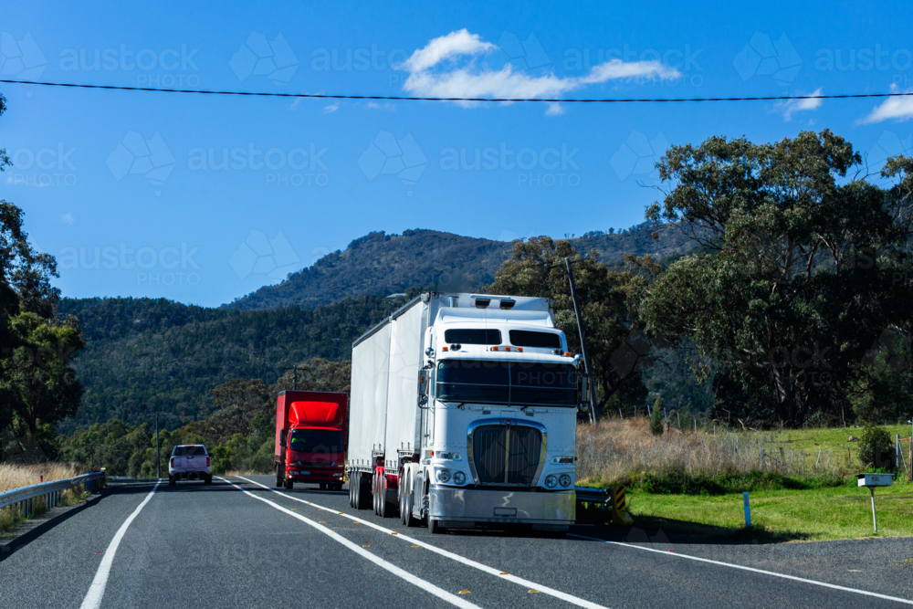 Image of Semi-trailer trucks travelling on country road in Australia in ...
