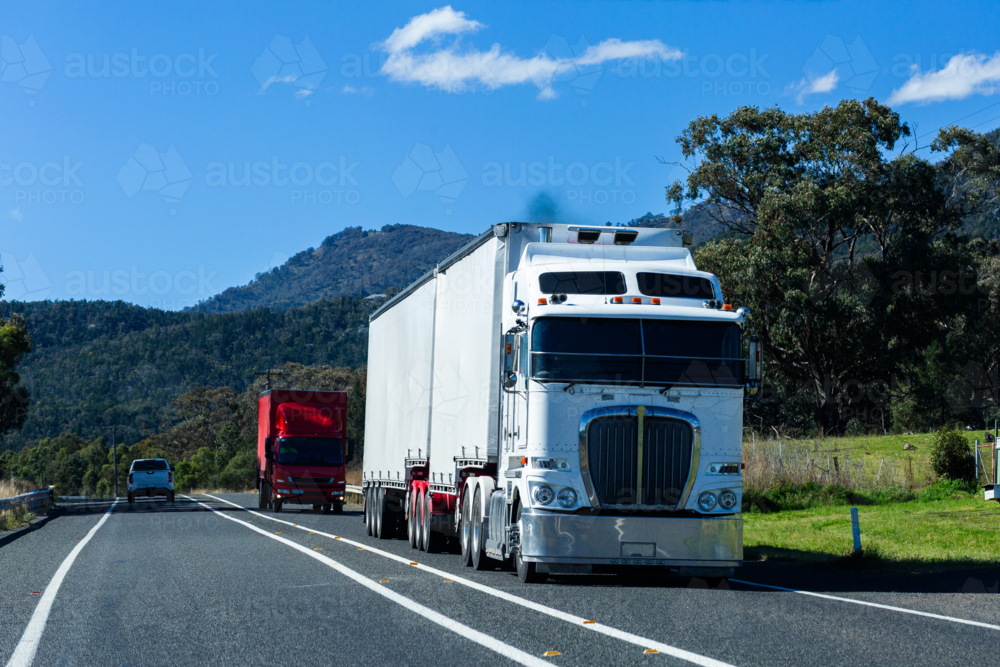 Image of Semi-trailer trucks travelling on country road in Australia in ...